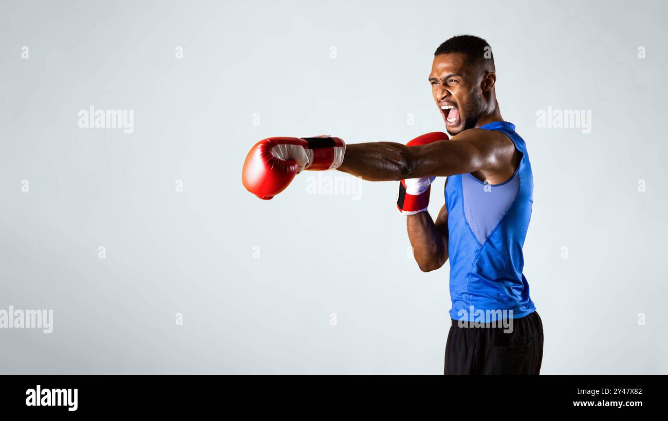 Athletic african fighter demonstrating boxing stance at studio Stock ...
