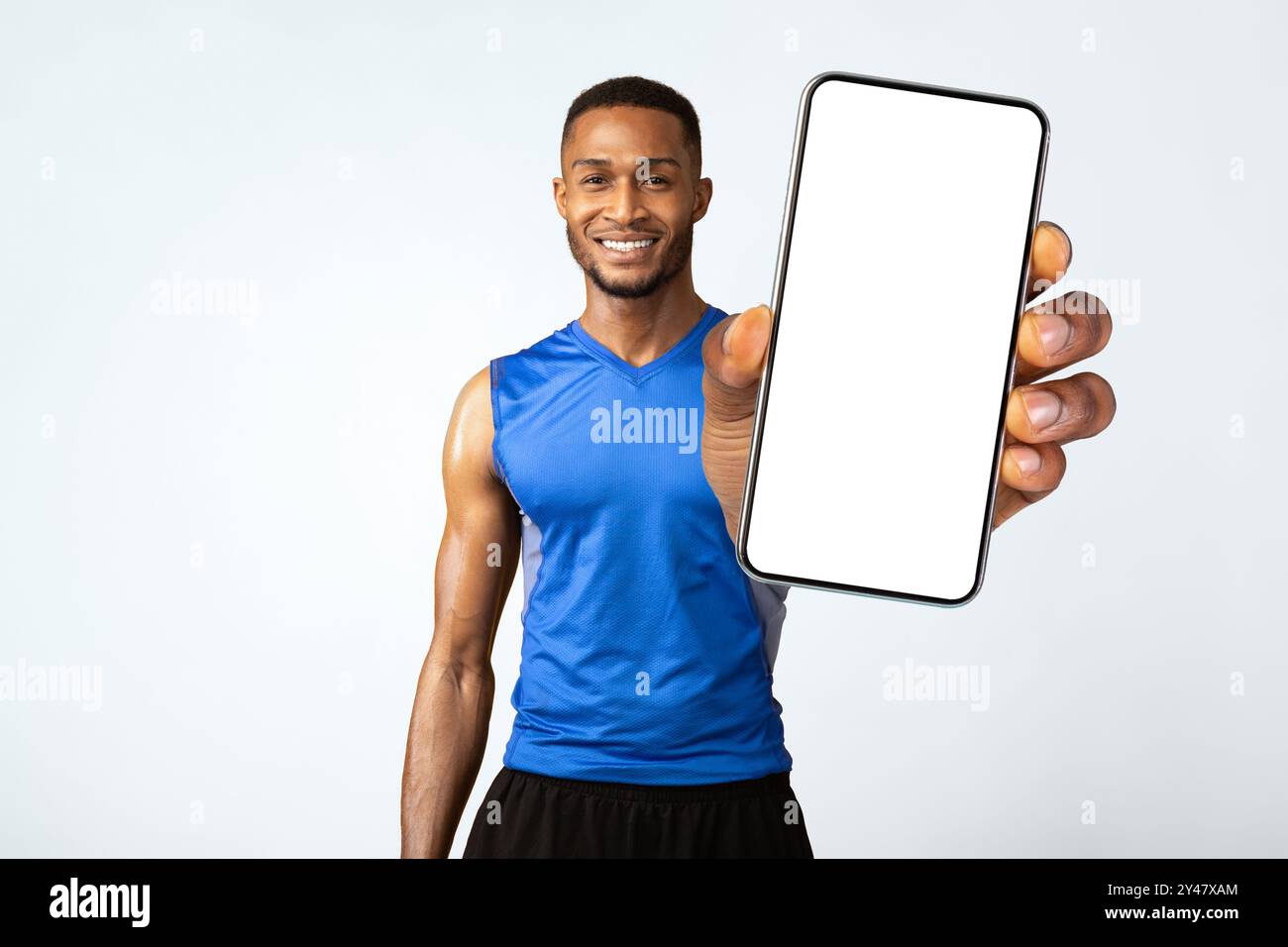 Healthy afro guy with fit body holding bottle of water Stock Photo - Alamy