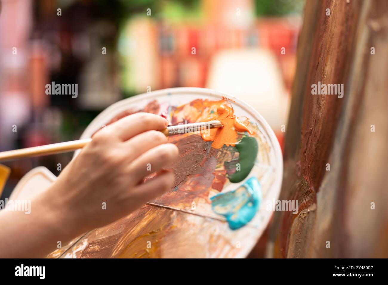 Talented artist painting an artwork with colorful paints mixed on a ...
