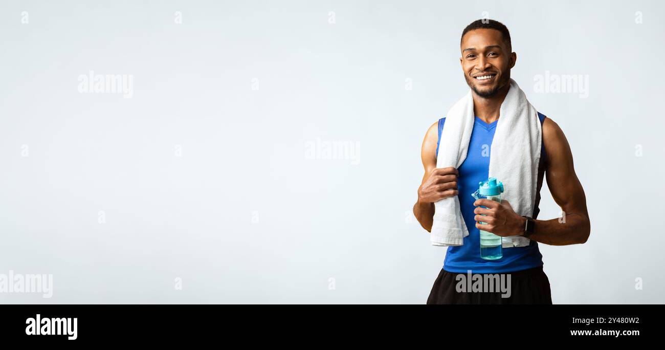 Healthy afro guy holding bottle of water Stock Photo - Alamy