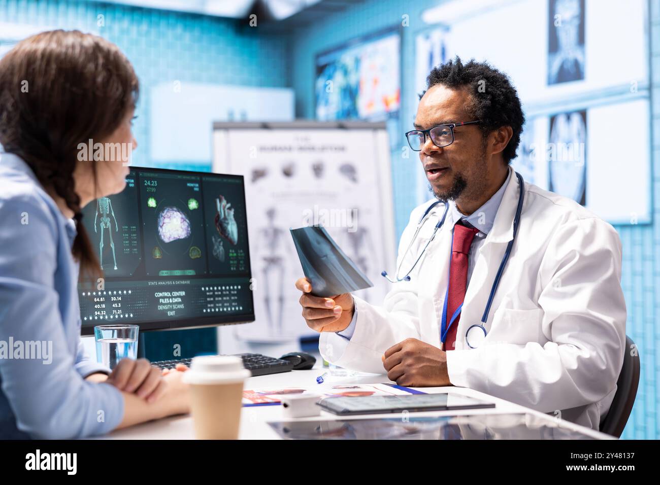 Professional medic analyzing x ray imaging and test findings in office ...