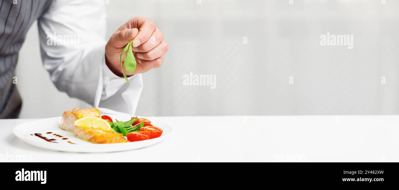 Male Chef Plating Fish Dish Standing In Kitchen, Cropped Stock Photo ...