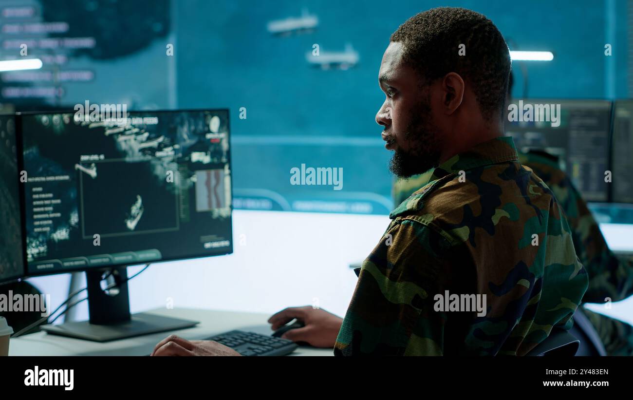 Team of military specialists overseeing surveillance activity by using ...