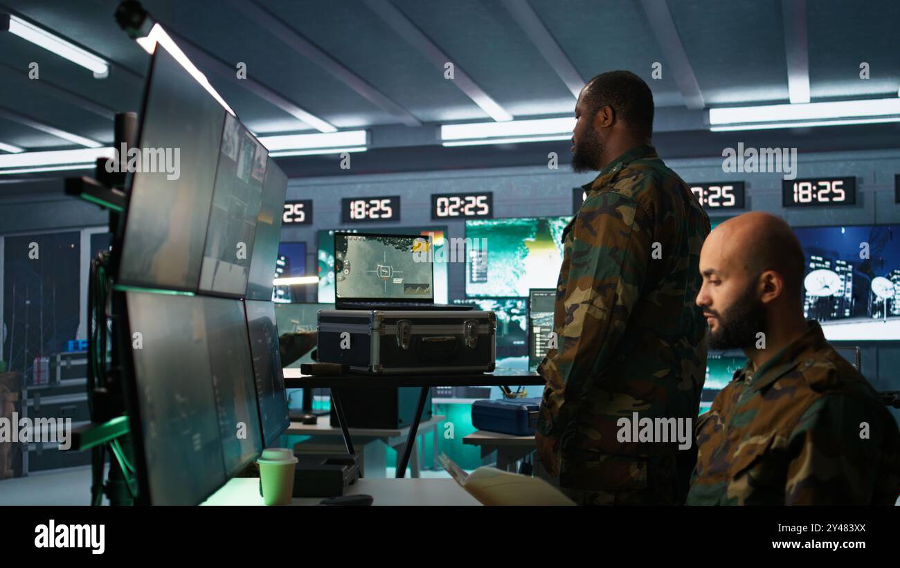 Military soldier wearing camo uniform in mission control center ...