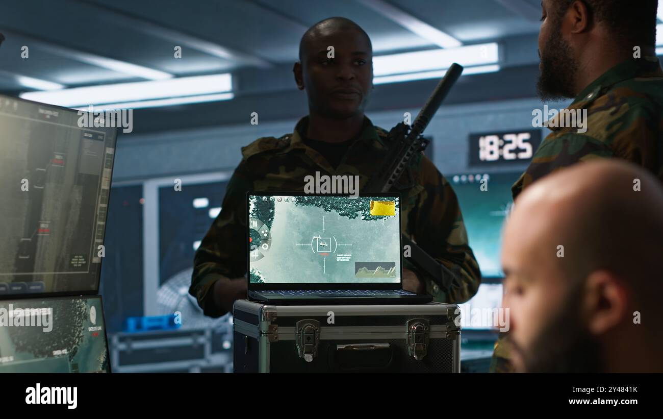 Military soldier wearing camo uniform in mission control center ...
