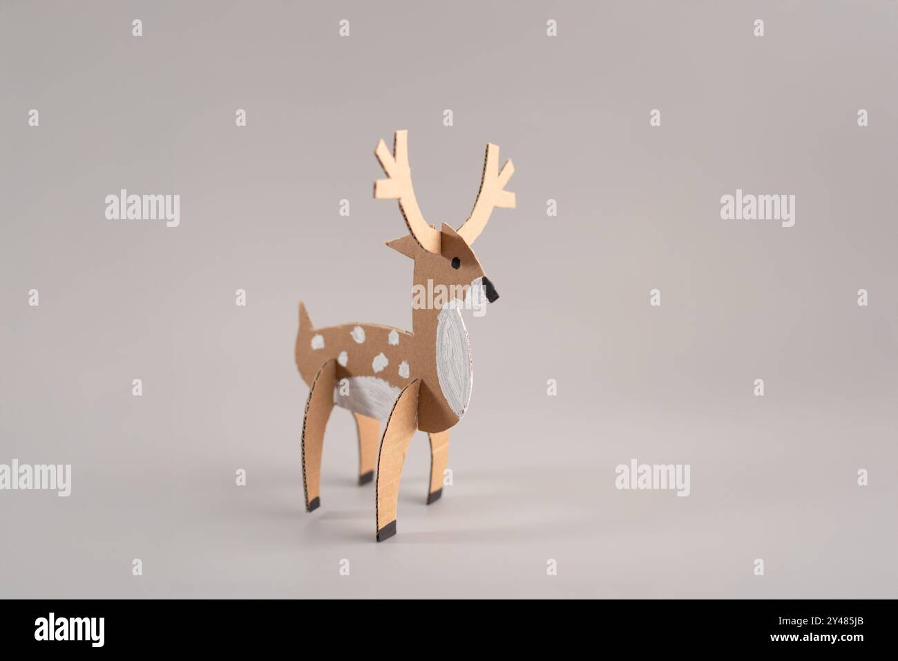 3D paper deer model with brown body, white spots, and antlers, standing ...