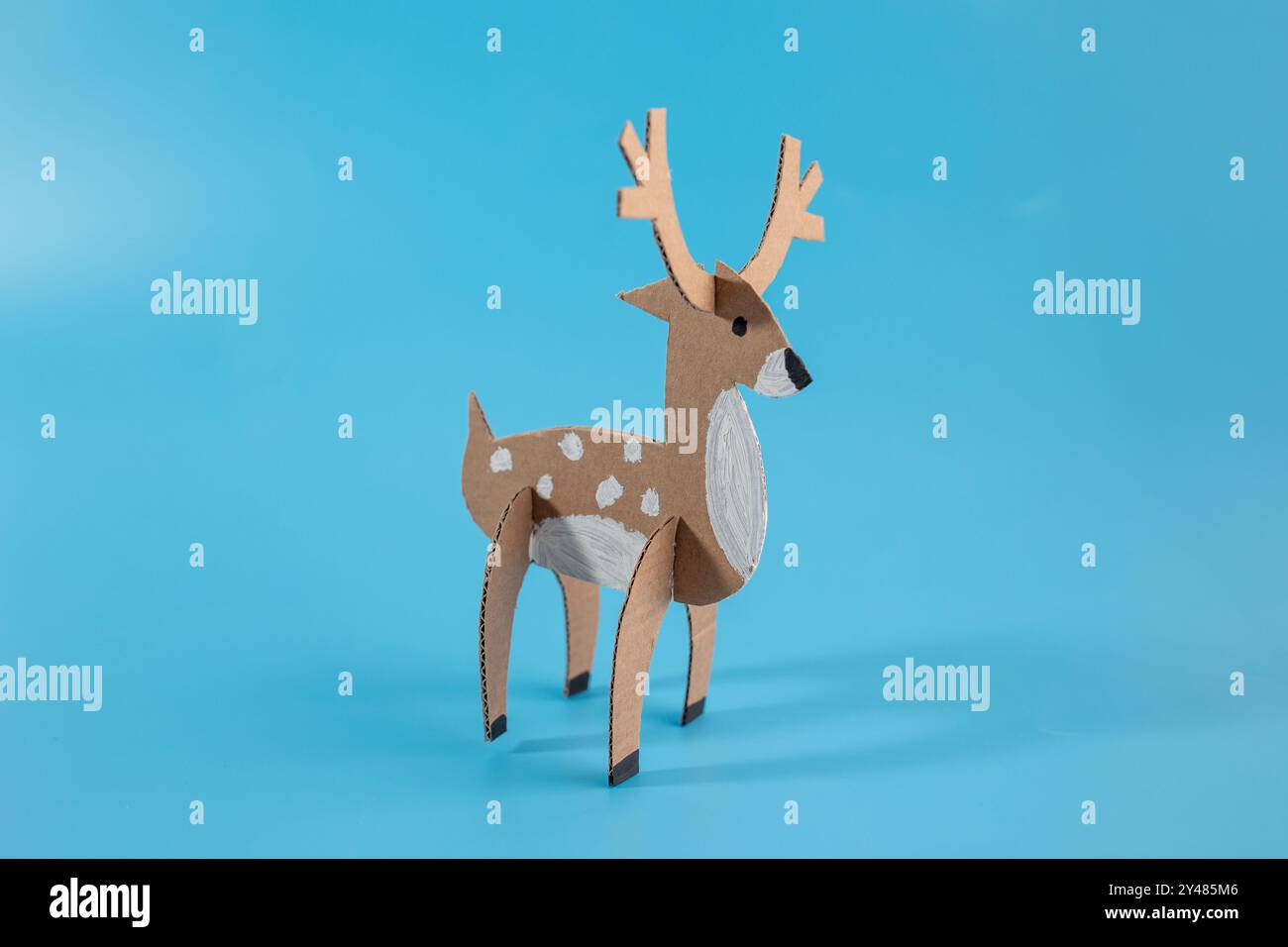 Deer paper craft model on plain background, recycling concept, ideal ...