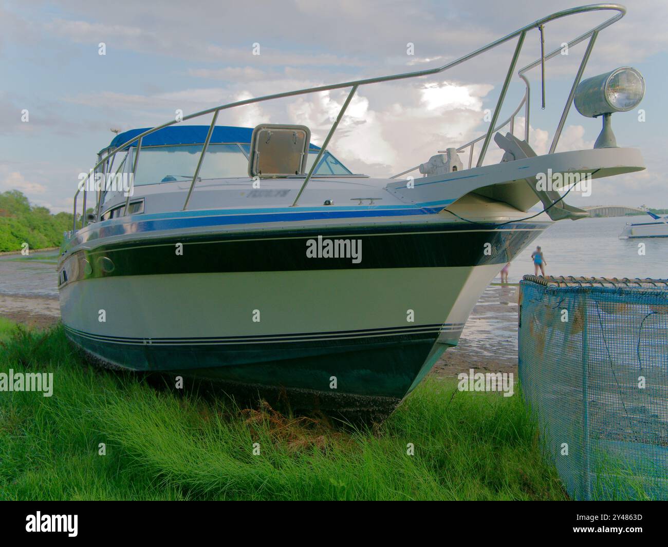 Wide view out towards washed up on shore tall large blue and white ...