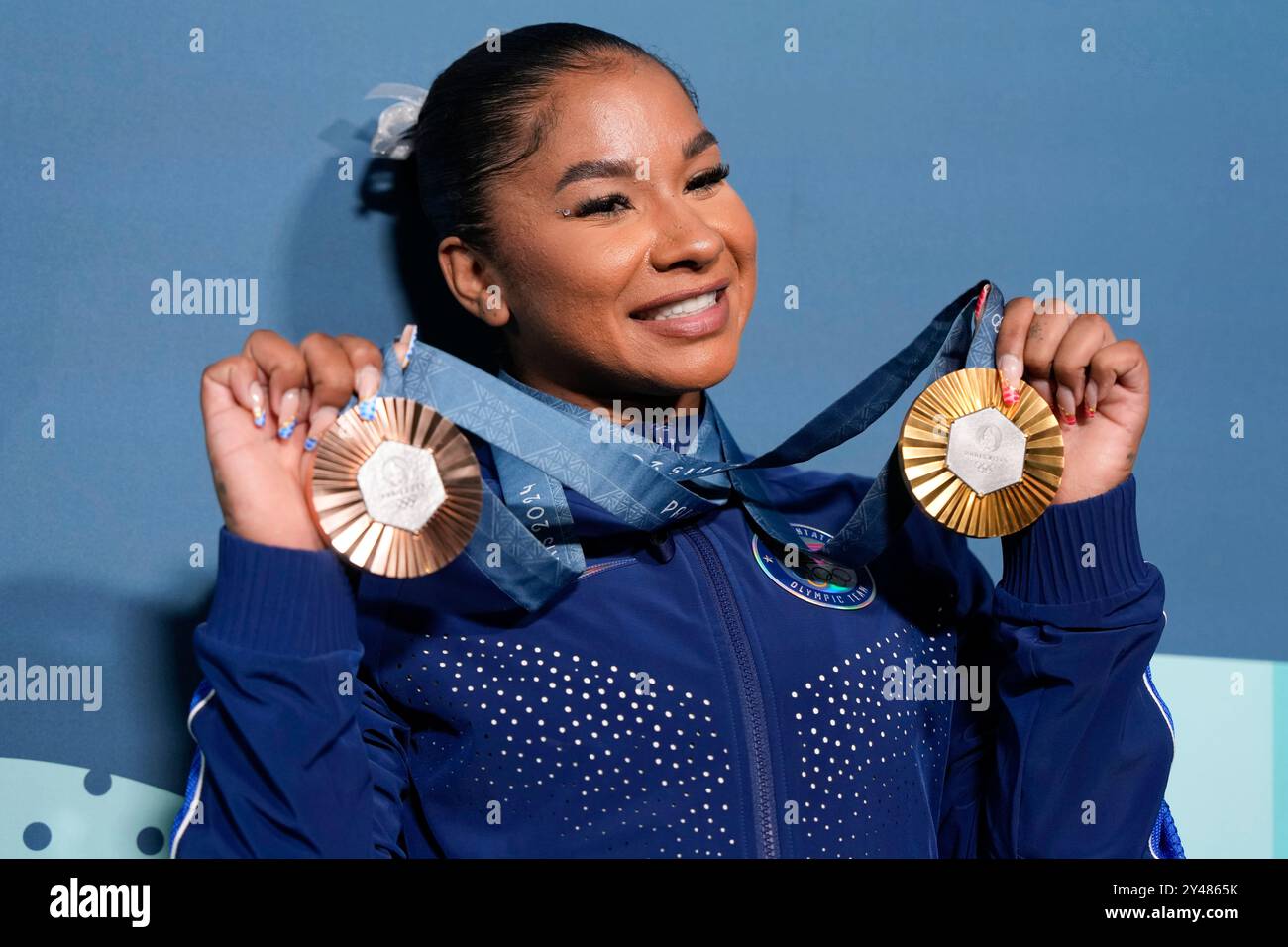 FILE - Jordan Chiles, of the United States, holds up her medals after ...
