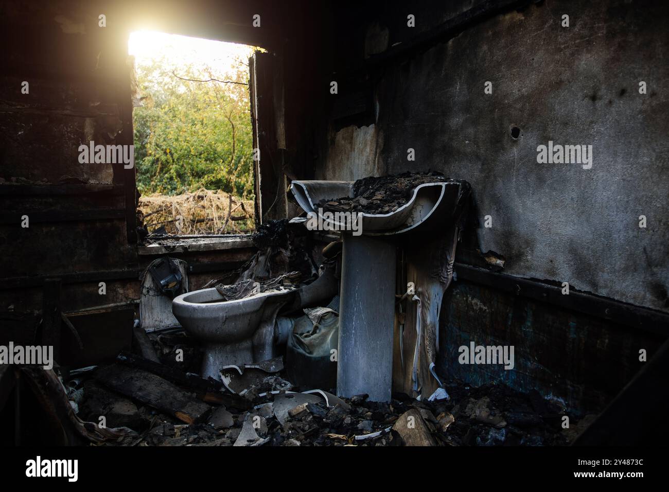 Burnt house interior. Burned burnt bathroom, Fused remains of furniture ...