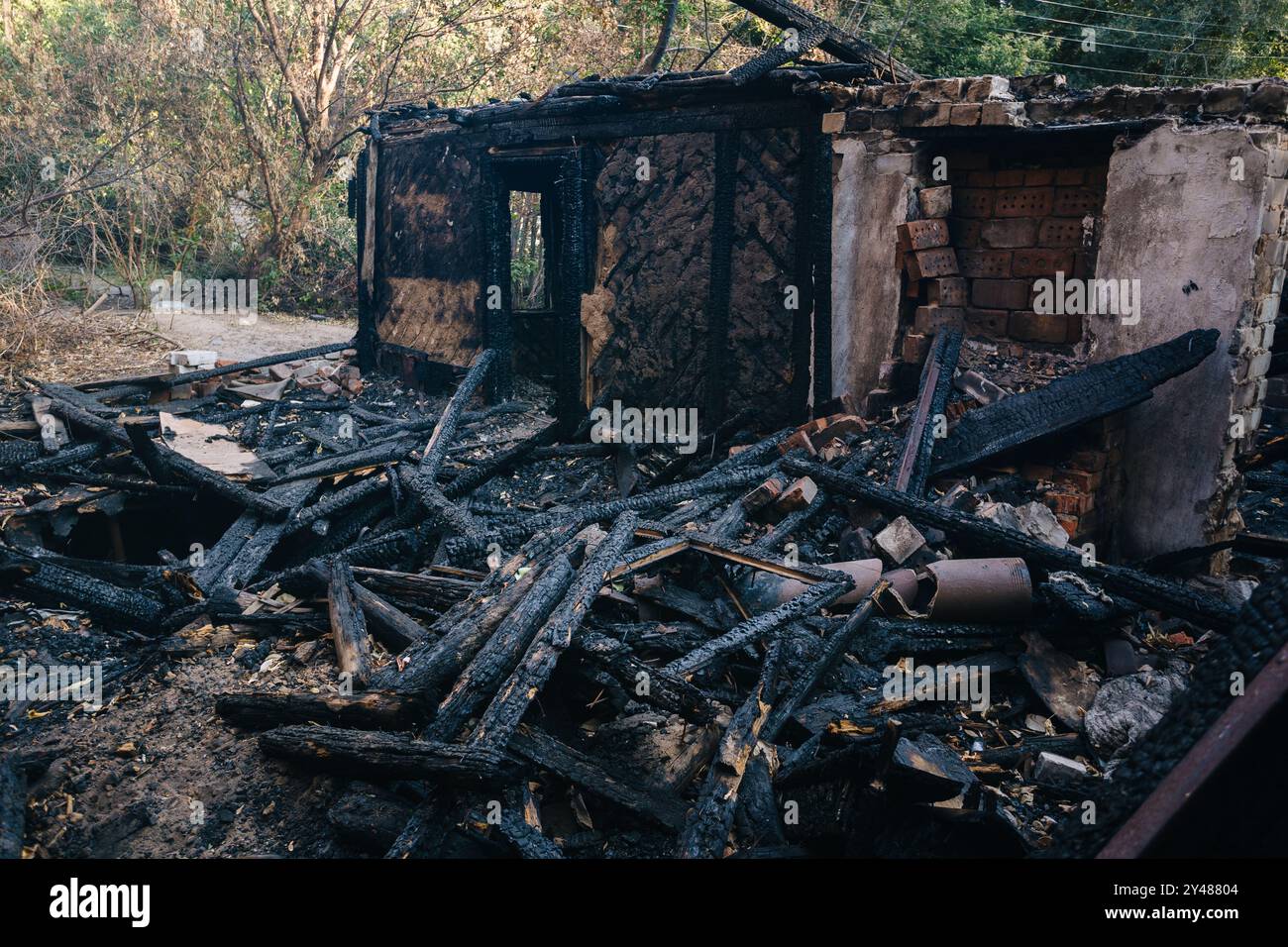 Consequences of fire. Completely burnt wooden house Stock Photo - Alamy