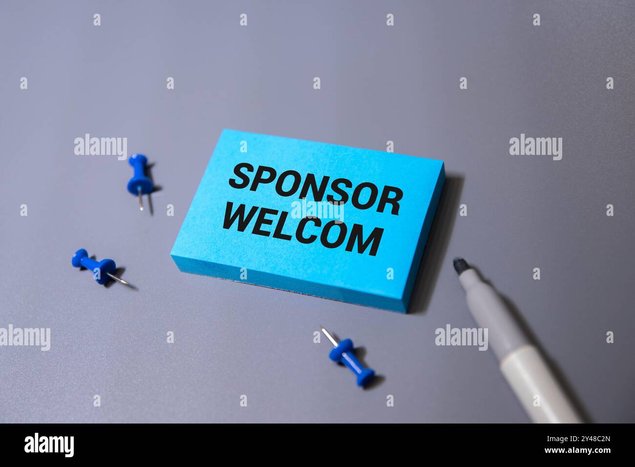 Yellow sticker on the dark gray texture background with text Sponsors ...