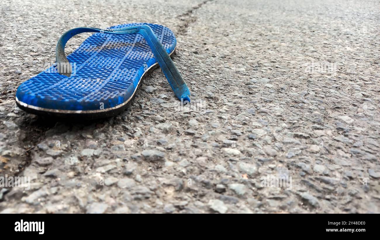 old grungy broken slippers taken low angle Stock Photo - Alamy