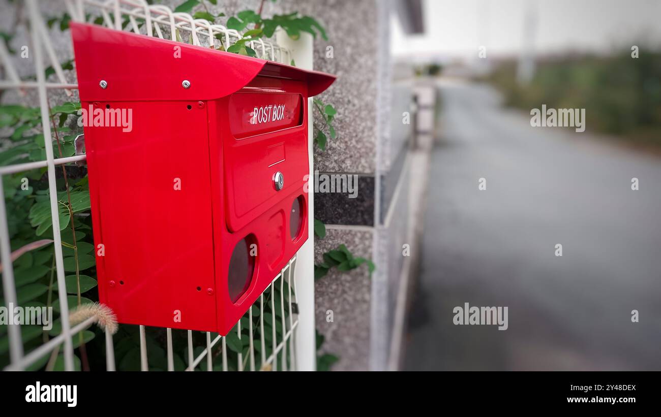 red post box on the fence Stock Photo - Alamy