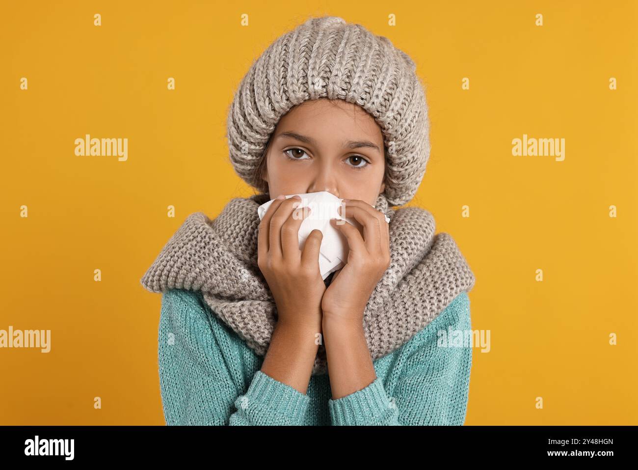 Cold symptom. Little girl with runny nose on orange background Stock ...