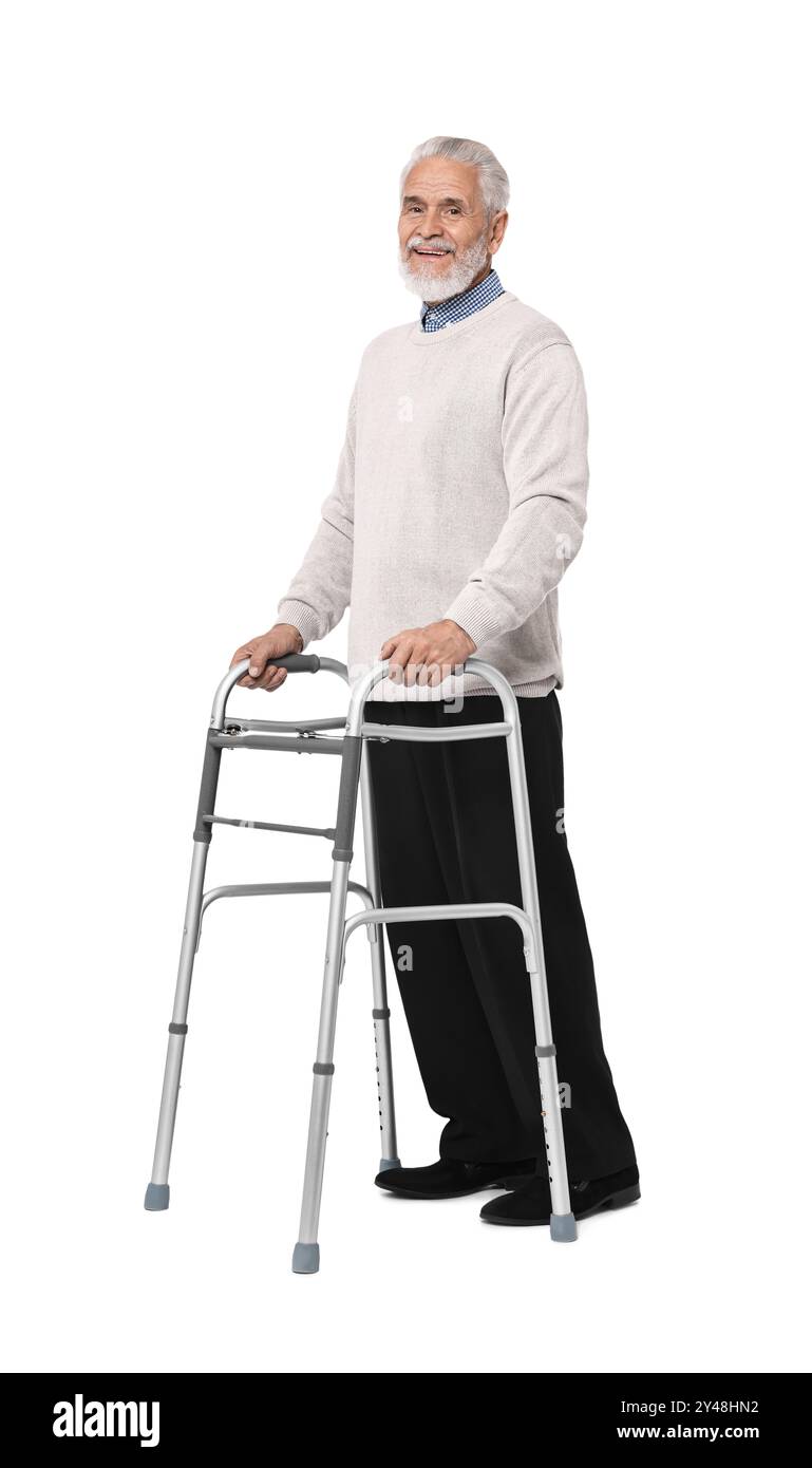 Senior man using walking frame on white background Stock Photo - Alamy