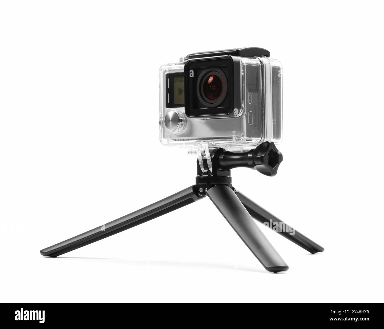Modern action camera and tripod on white background Stock Photo - Alamy