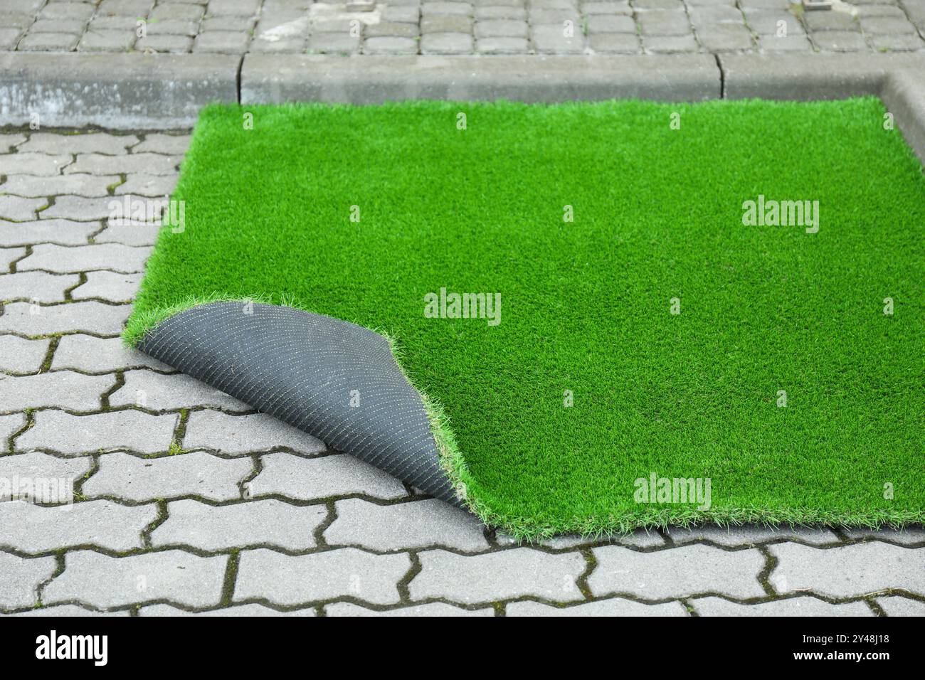 Sheet of green artificial turf in yard Stock Photo - Alamy