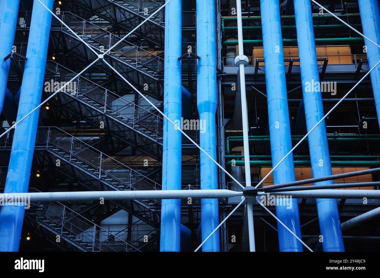 Modern industrial architecture with blue pipes and structural ...