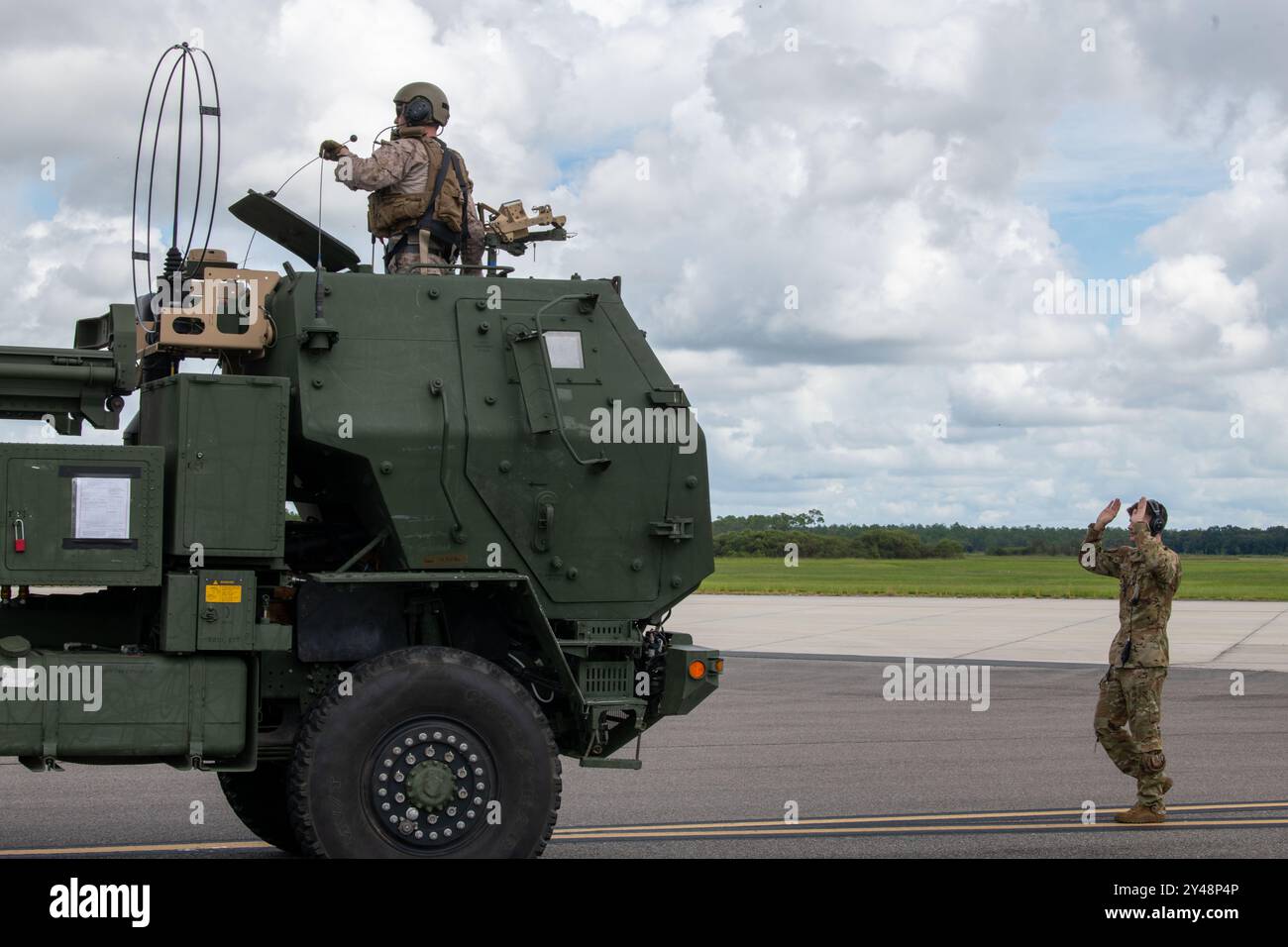 Senior Airman Casey Lawson, 16th Airlift Squadron loadmaster, guides a ...