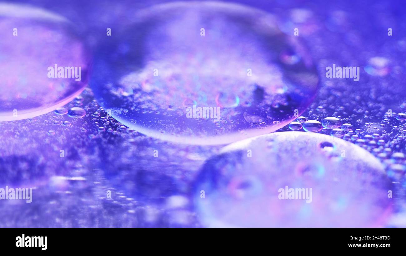 Oil bubbles. Serum gel. Defocused neon purple blue color glitter ...