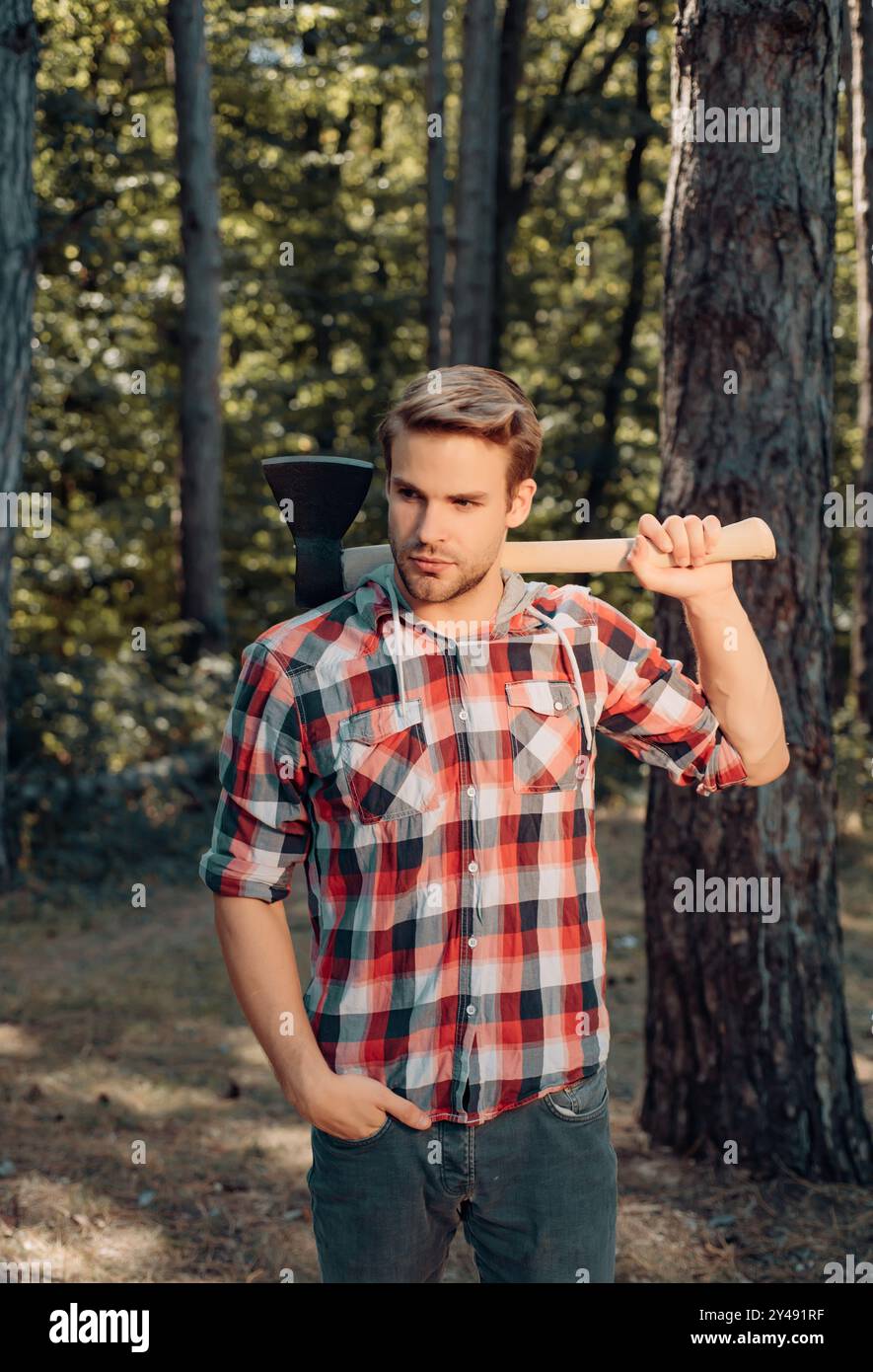 Harvest of timber. Lumberjack worker walking in the forest with axe ...