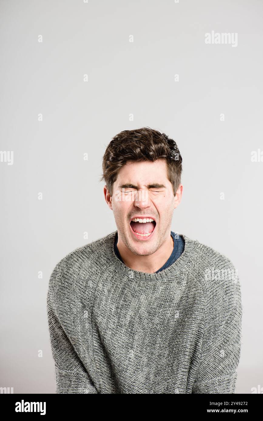 Shouting, screaming and face of man in studio with anger, upset and ...