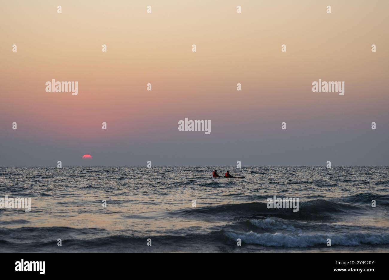 GOA, India - February 18, 2024: Silhouettes of two people sailing on a ...