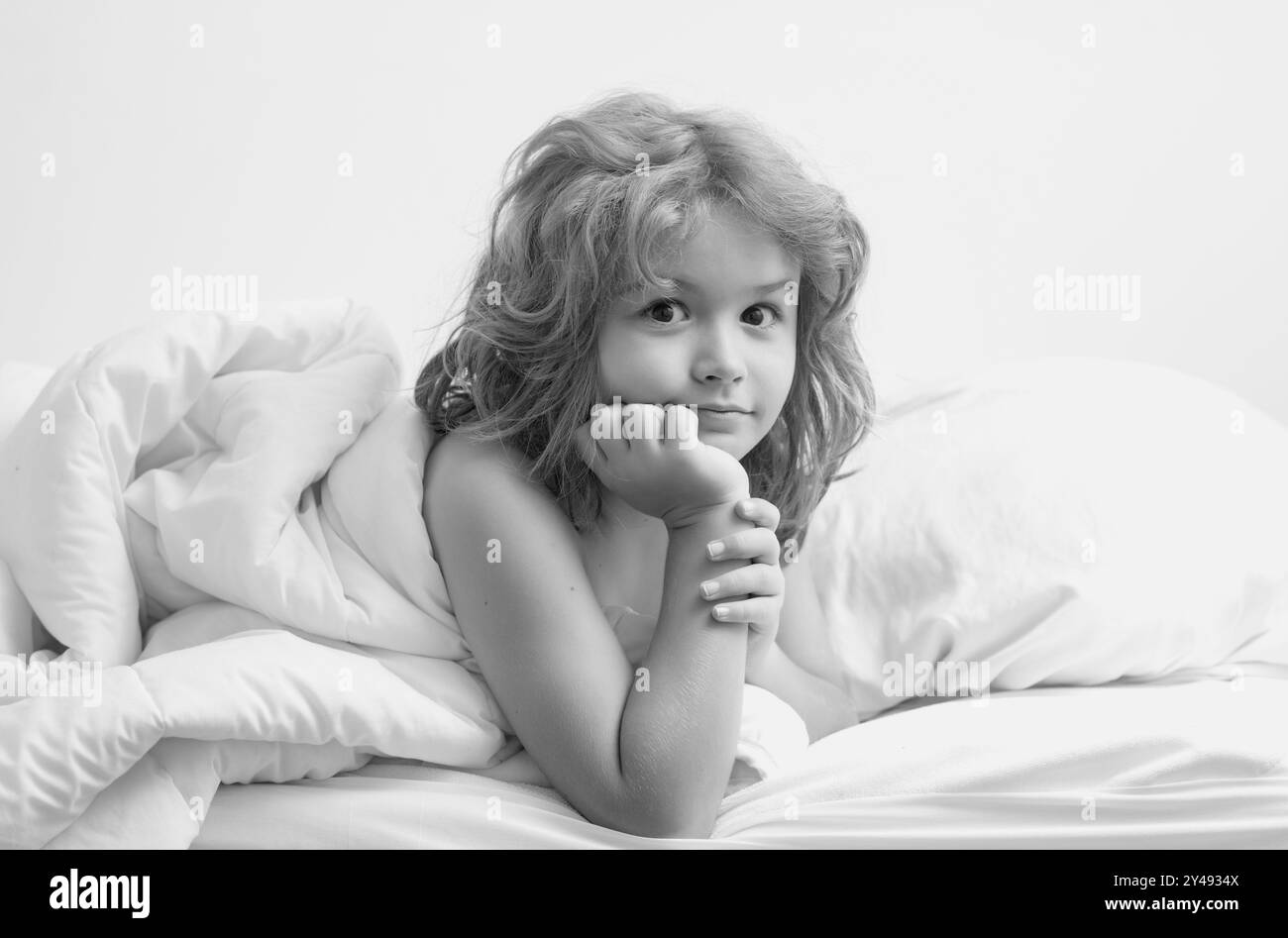 Child wakes up in the morning in the bedroom. Cute little boy waking up in bed Stock Photo - Alamy