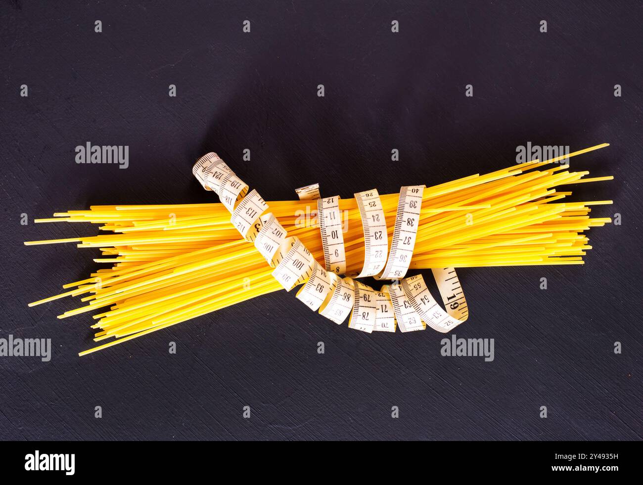 string spaghetti on black background, raw pasta Stock Photo - Alamy