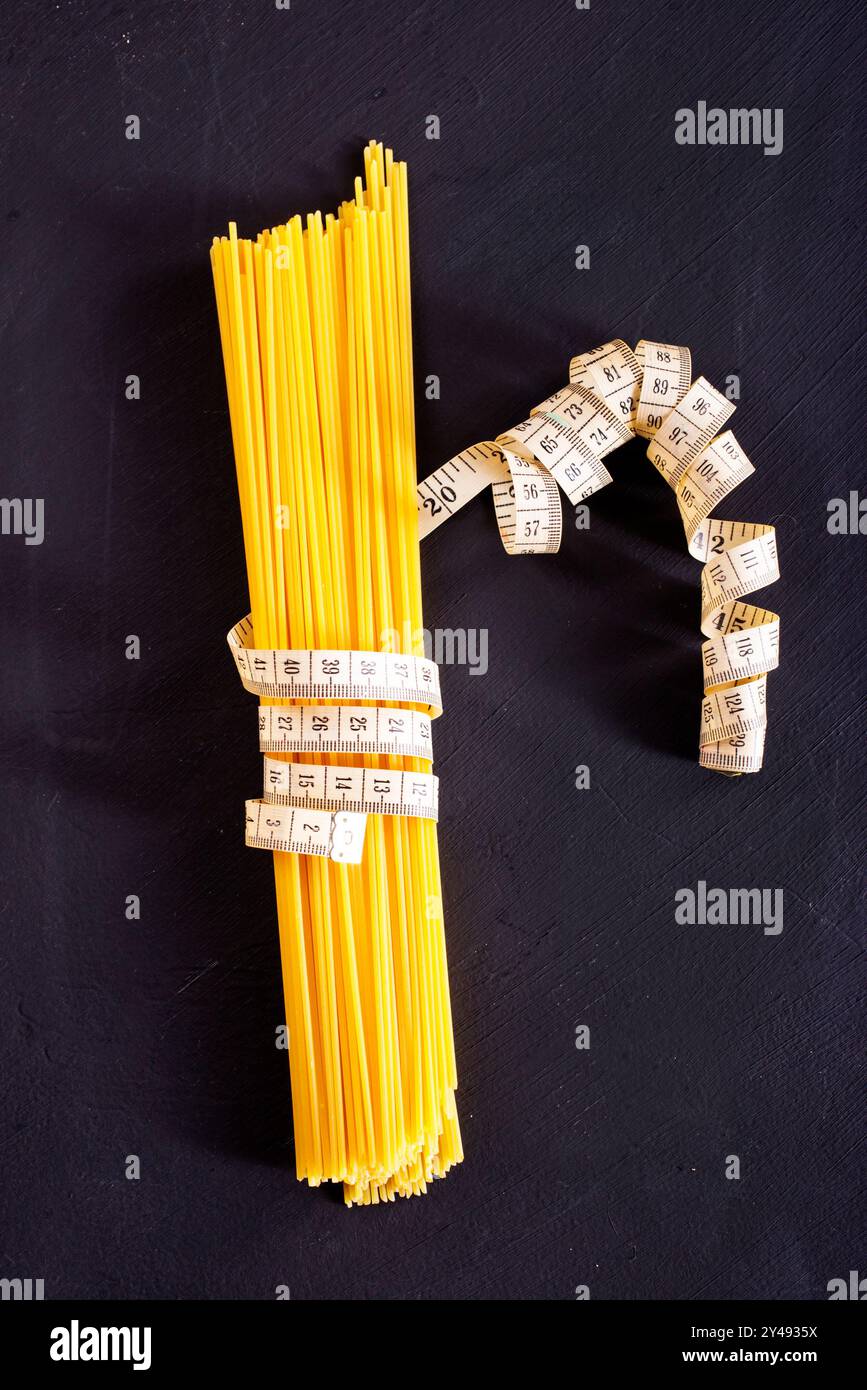 string spaghetti on black background, raw pasta Stock Photo - Alamy
