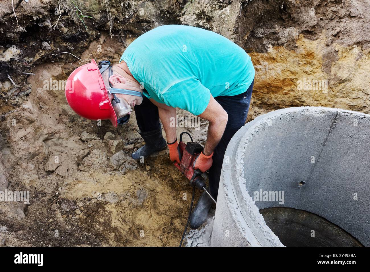 Chiselling concrete ring of rotary hammer with chisel, builder drives ...