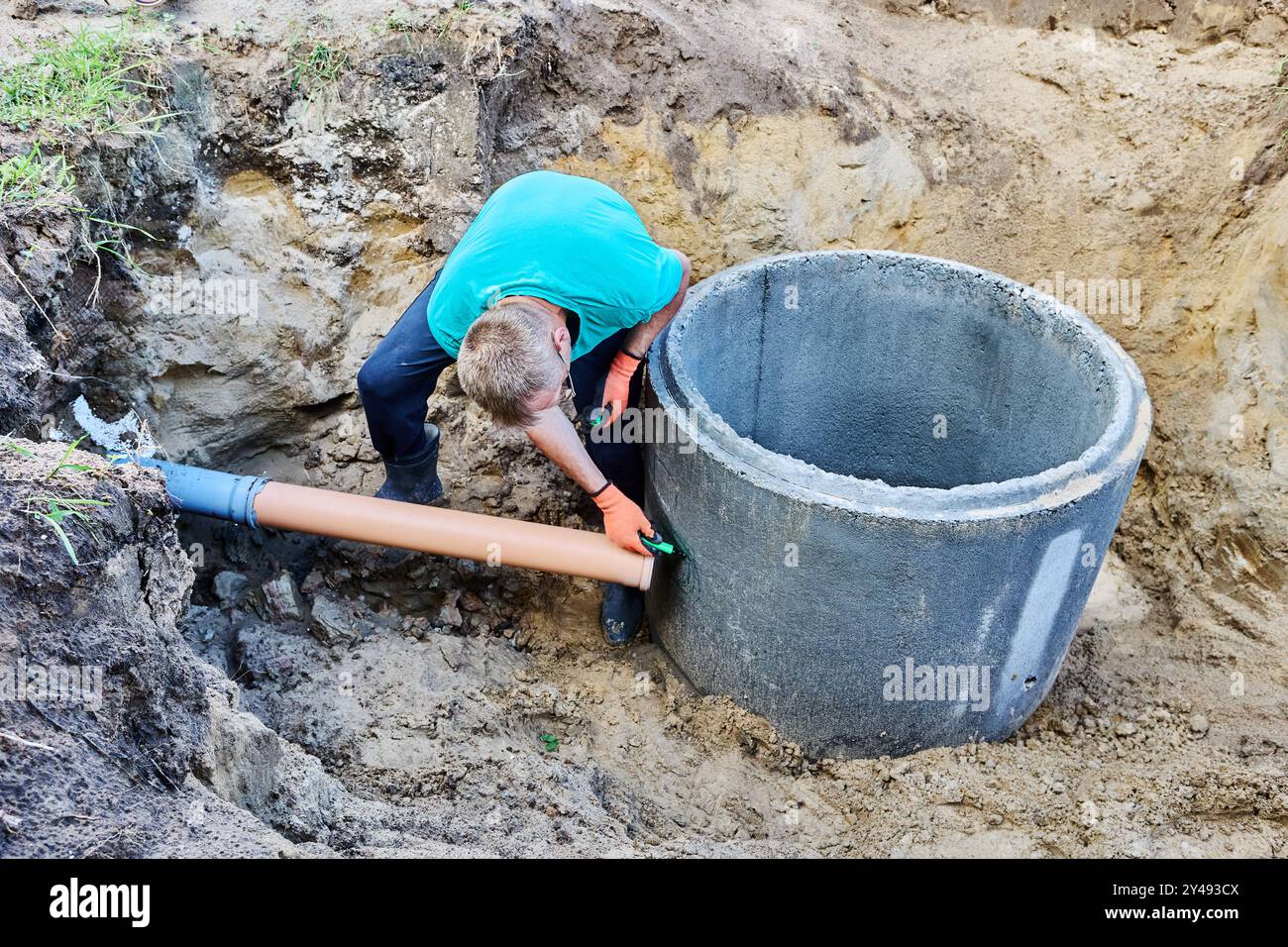 Installing an inlet pipe in septic system made of concrete rings ...