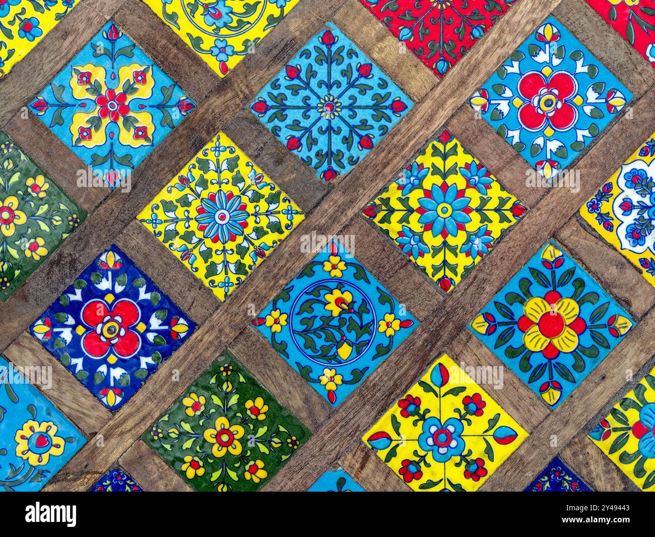 Details of the colorful tiles inlaid on a wood tabletop Stock Photo - Alamy