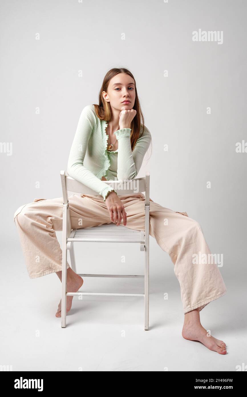 Young Woman Model Sitting and Posing in Studio Stock Photo - Alamy