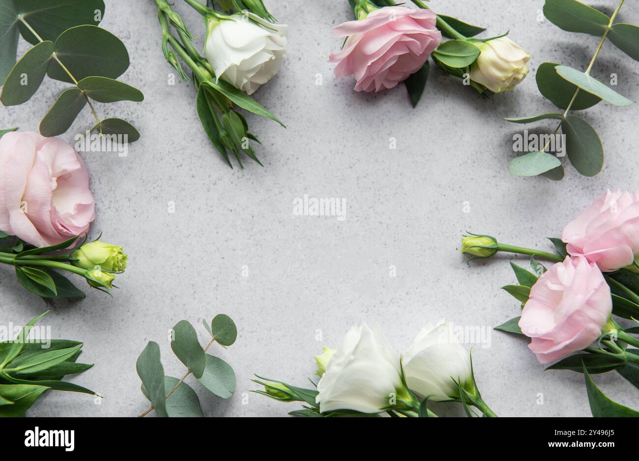 A beautiful assortment of pink, white, and cream flowers are artfully ...