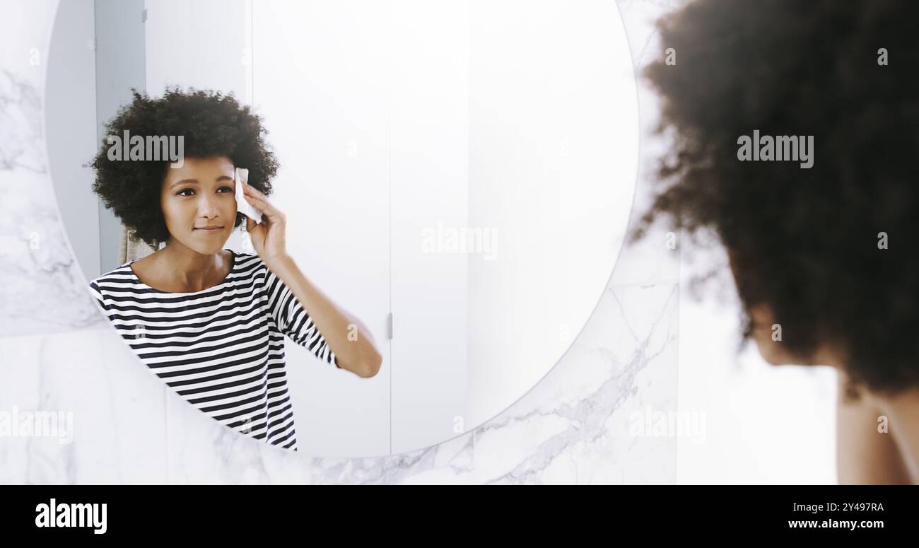 Wipe, mirror and girl in bathroom with face tissue, cleanser or morning ...
