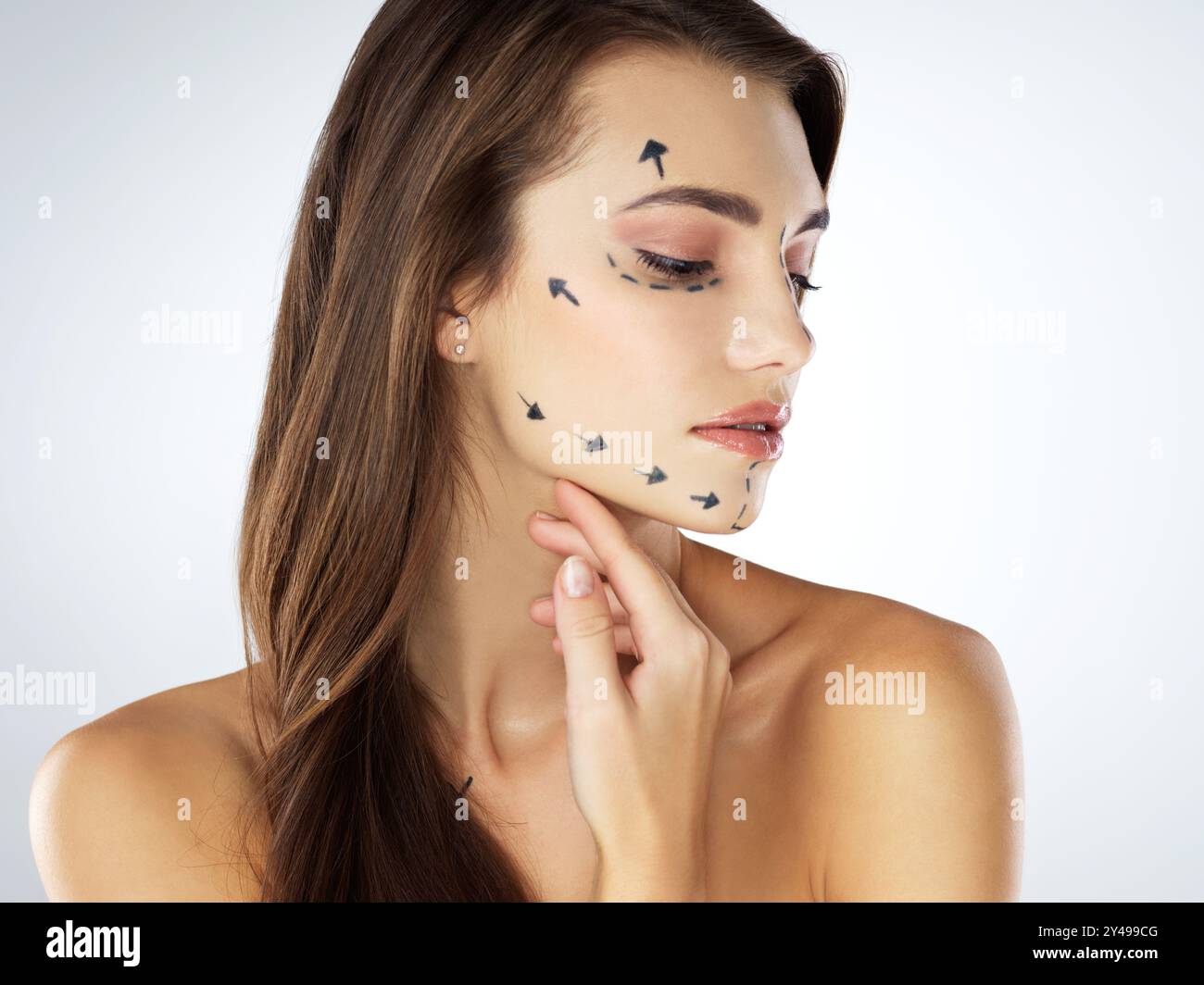 Woman, face and arrows in studio for plastic surgery, chin augmentation ...