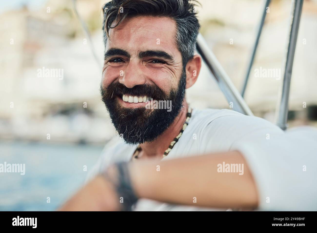 Portrait, man and smile on yacht for luxury, fun and adventure in ocean ...
