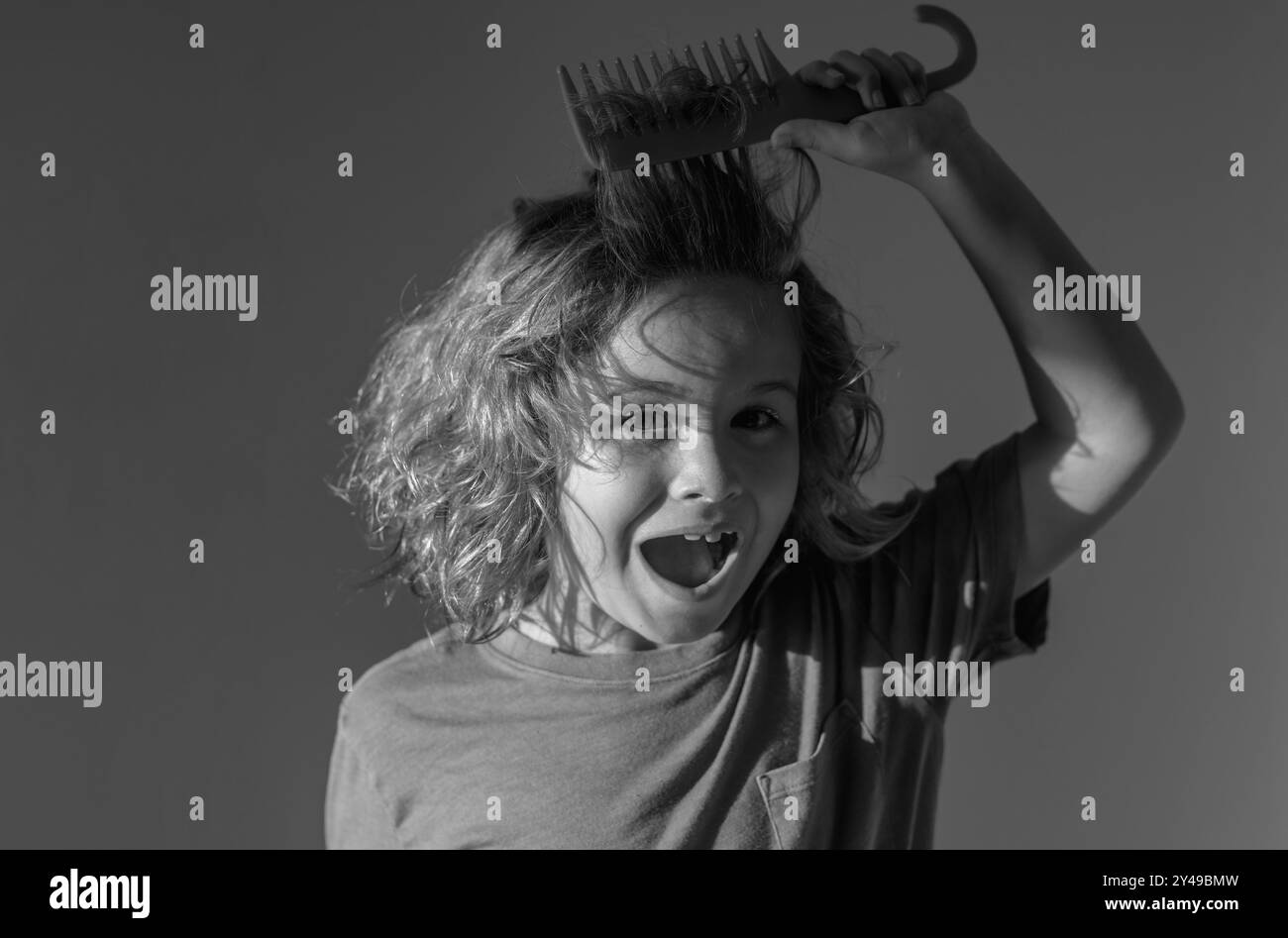 Comb and hair brush concept. Kid boy makes face expressions, combing ...