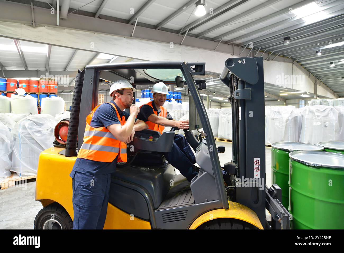 group of workers in the logistics industry work in a warehouse with ...