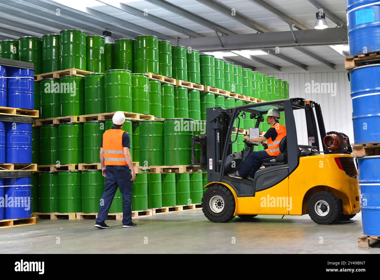 group of workers in the logistics industry work in a warehouse with ...