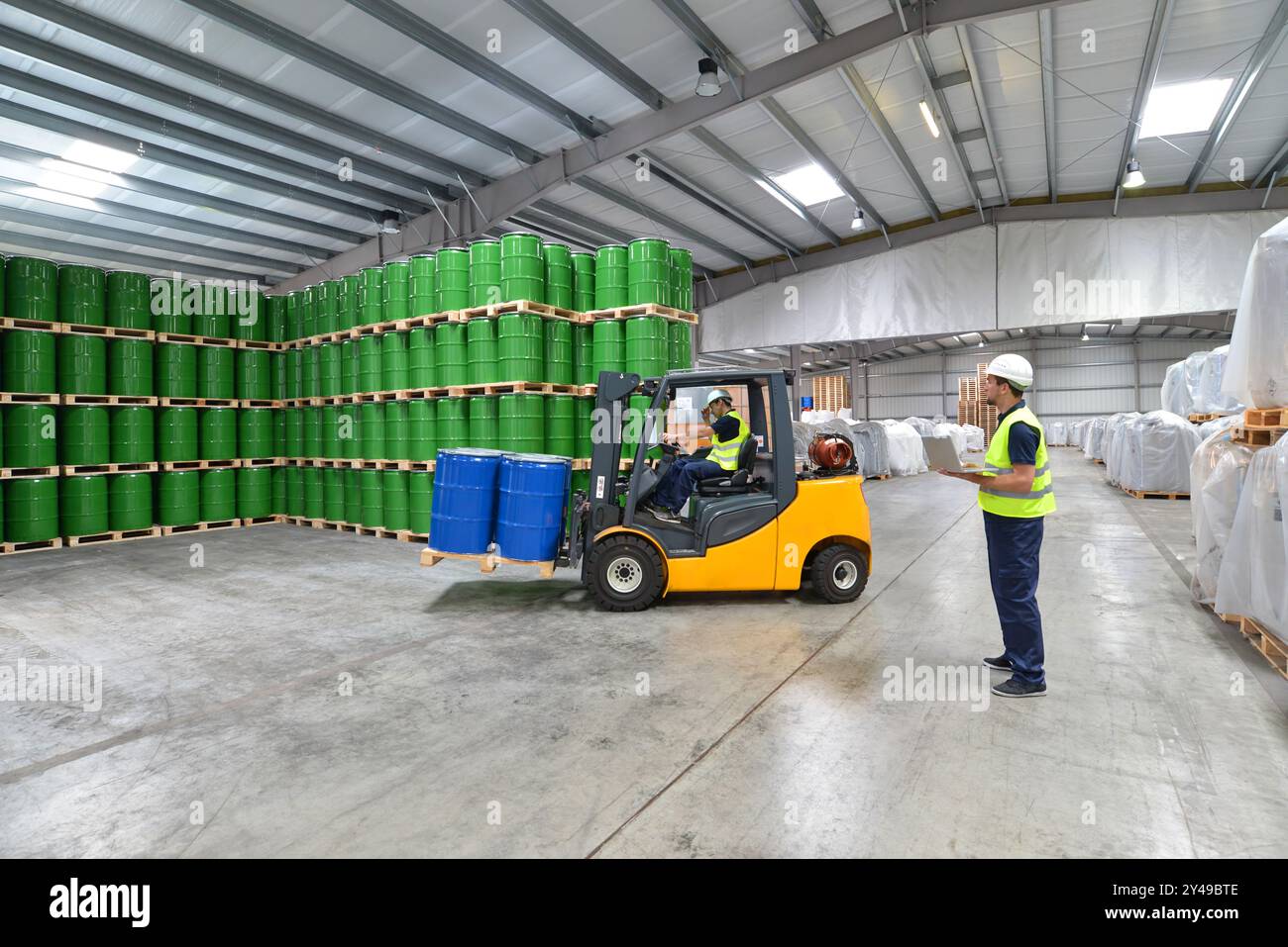 group of workers in the logistics industry work in a warehouse with ...