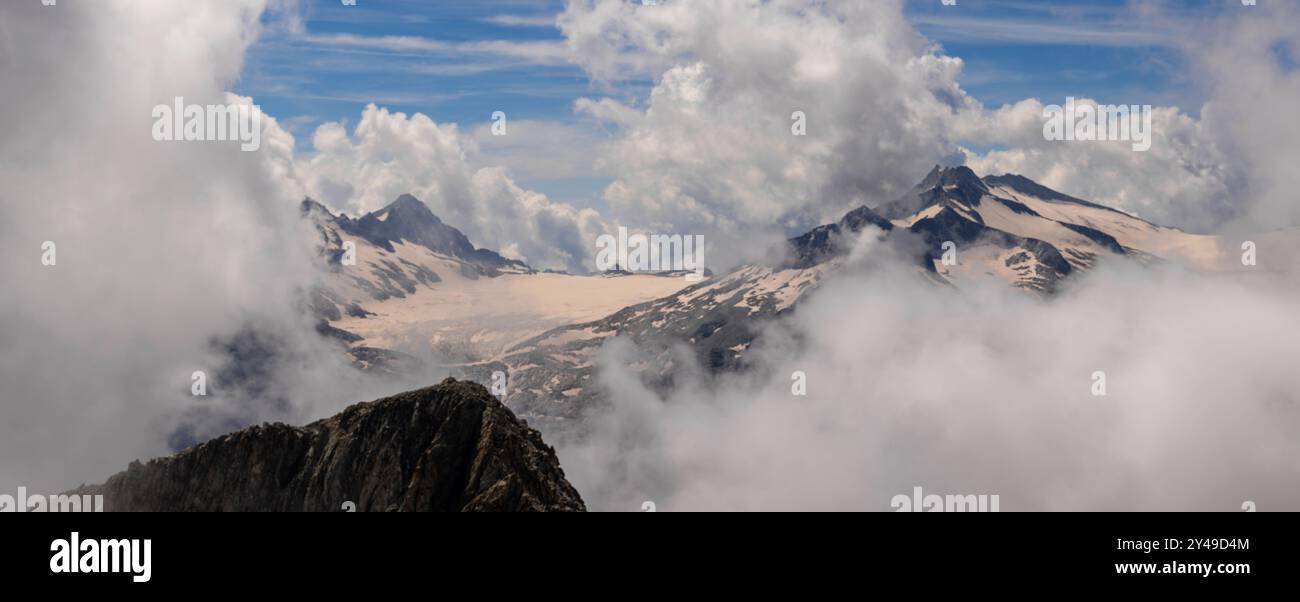 Majestic Mountain Peaks Emerging Through Clouds Stock Photo - Alamy