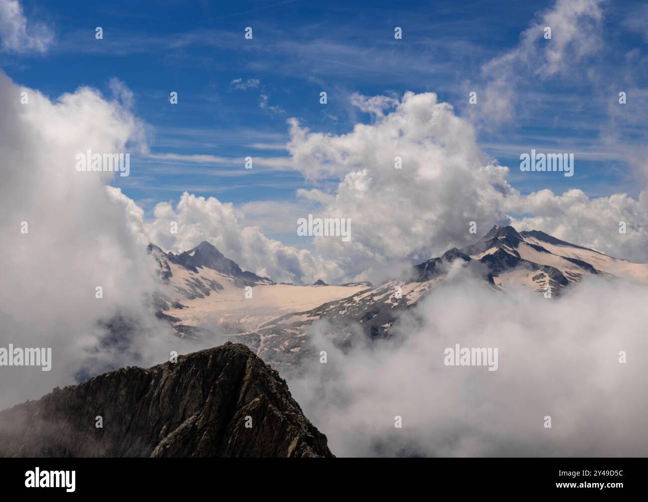 Majestic Mountain Peaks Emerging Through Clouds Stock Photo - Alamy