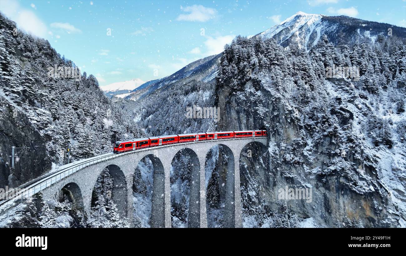 Snow falling and Train passing through famous mountain in Filisur ...