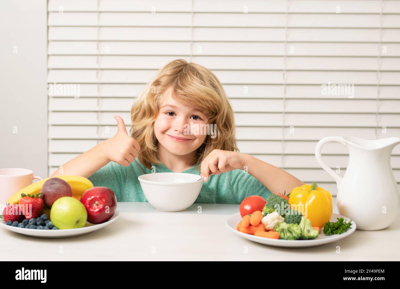 Morning snack with muesli cereal granola. Child in the kitchen at the ...