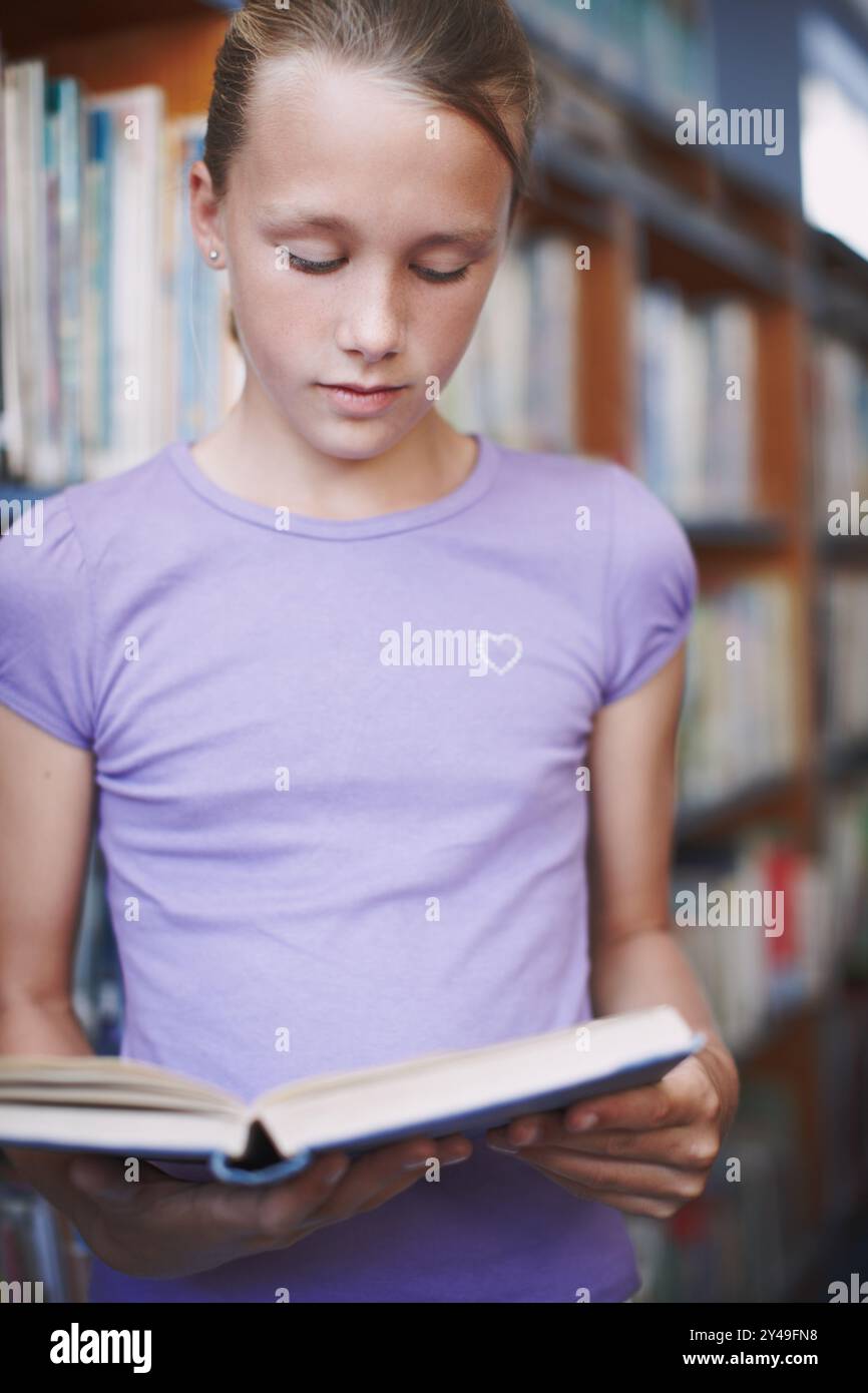 Child, reading book and library as student or preteen in school for ...