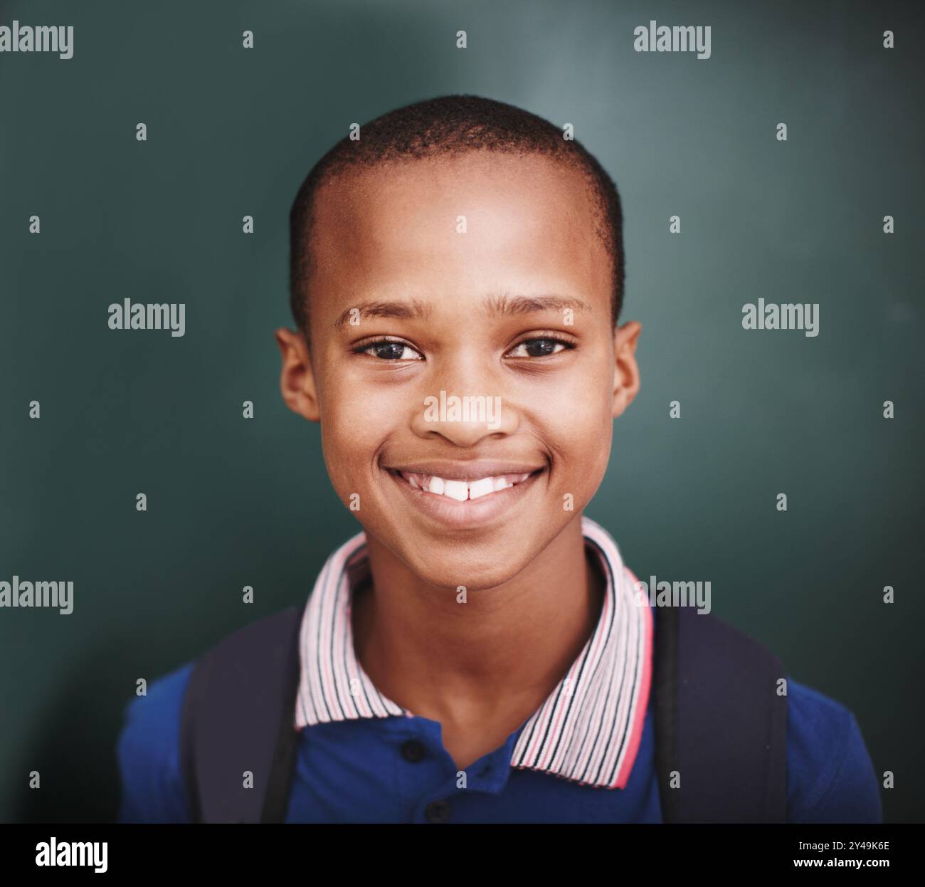 Learning, portrait and smile of boy on chalkboard in school classroom ...