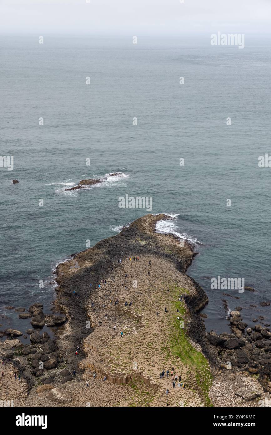 Aerial view of Giant's Causeway with tourists walking on the famous ...